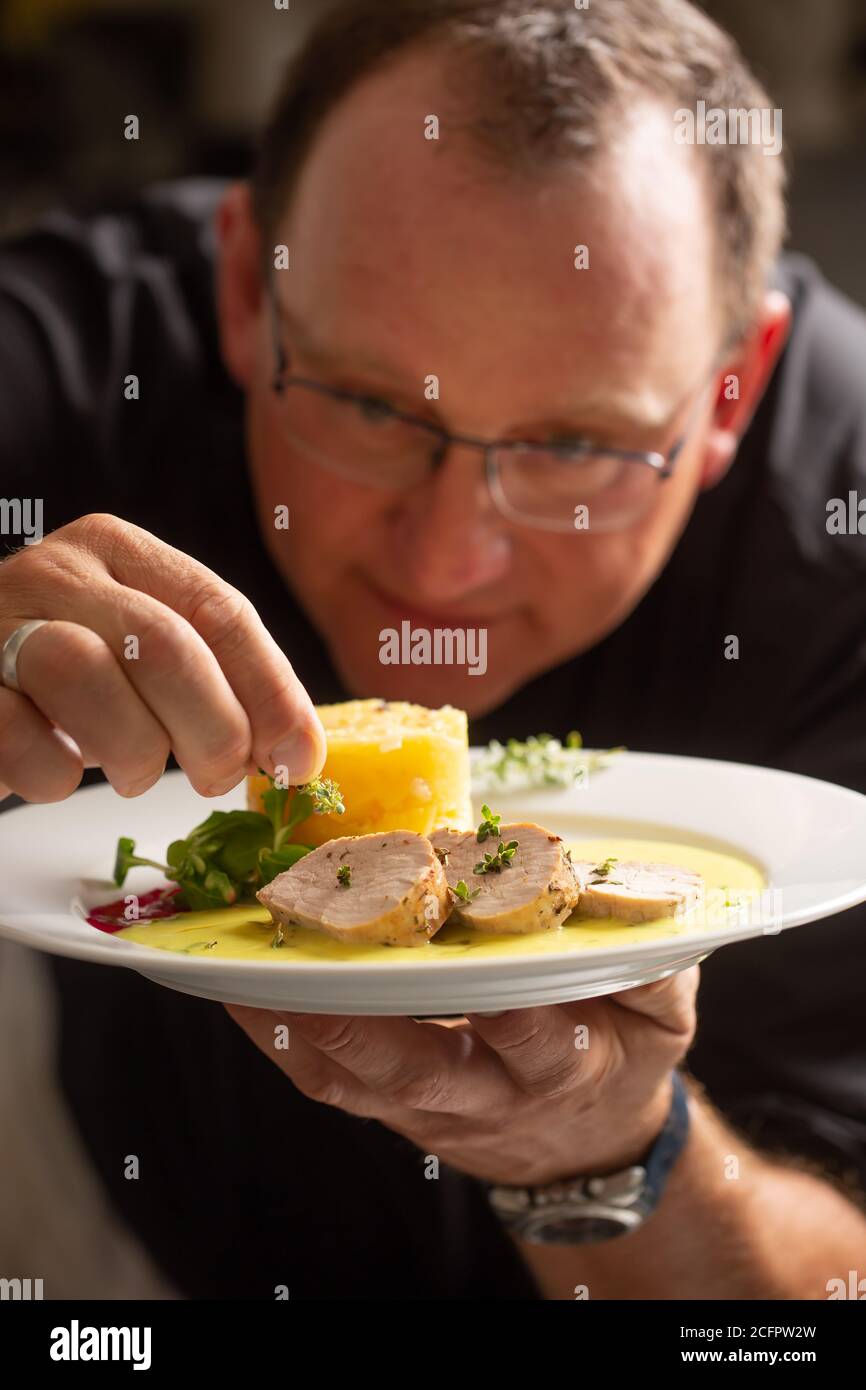 Chef in hotel or restaurant kitchen cooking only hands. He is working ...