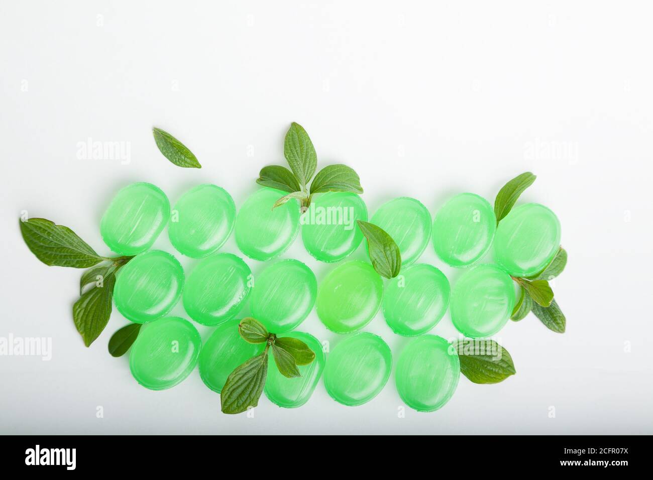 Bunch of cough lozenges with mint green leaves Stock Photo - Alamy