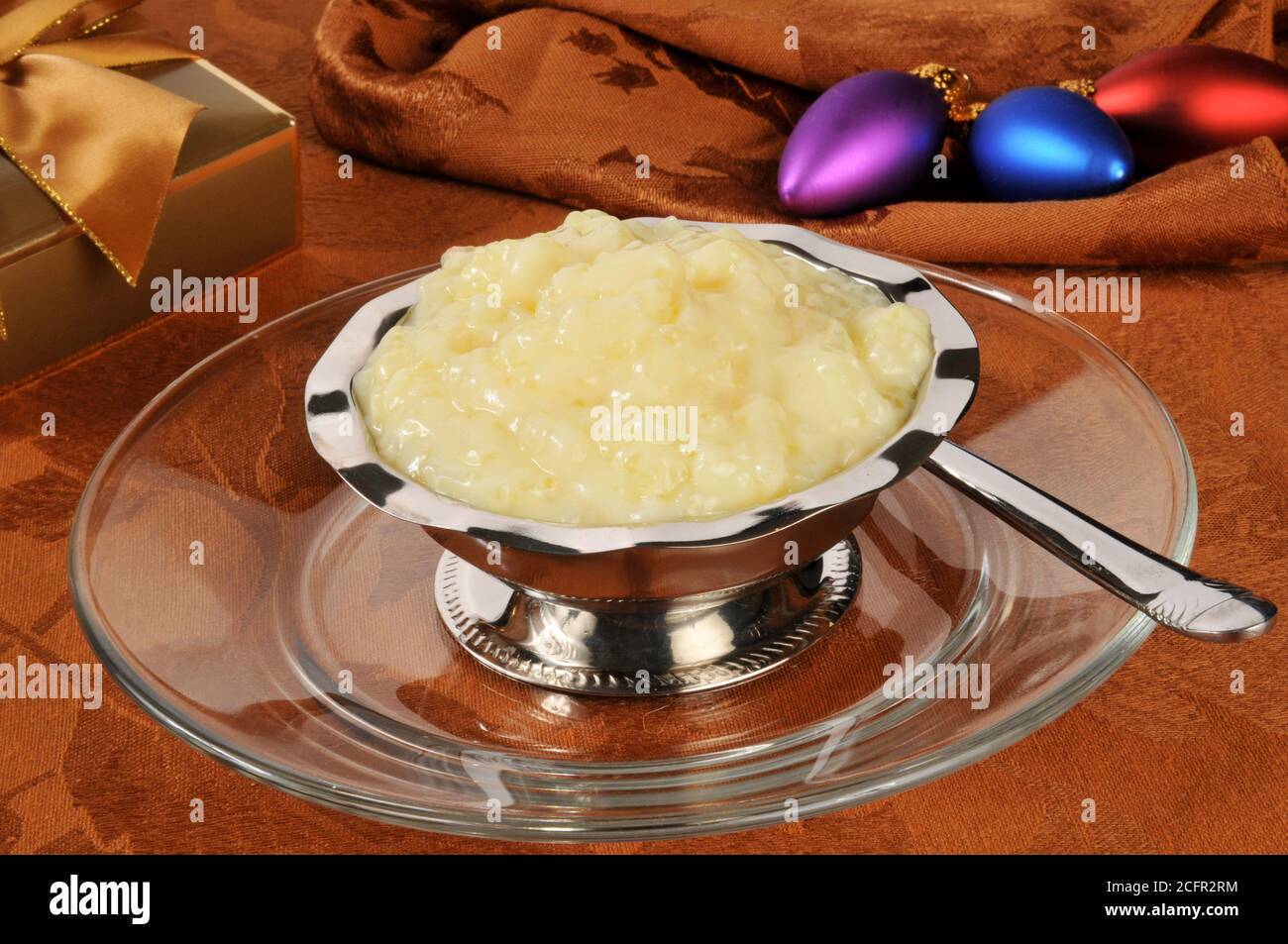 A silver dessert cup of tapioca pudding on a Christmas dinner table ...