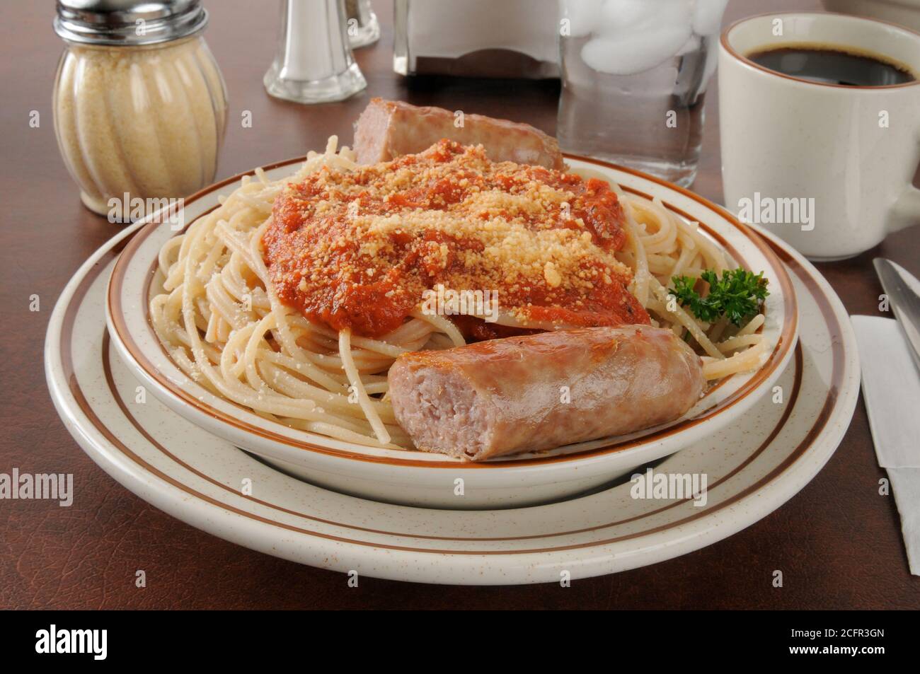 A bowl of spaghetti with sausage and parmesan cheese Stock Photo - Alamy