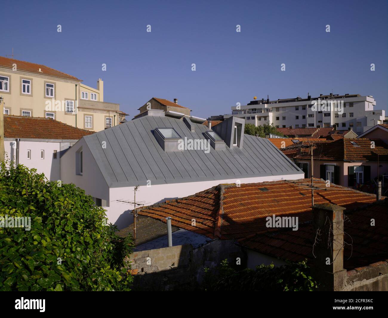 Roofscape with modern volume. Alto de Vila House, Porto, Portugal ...