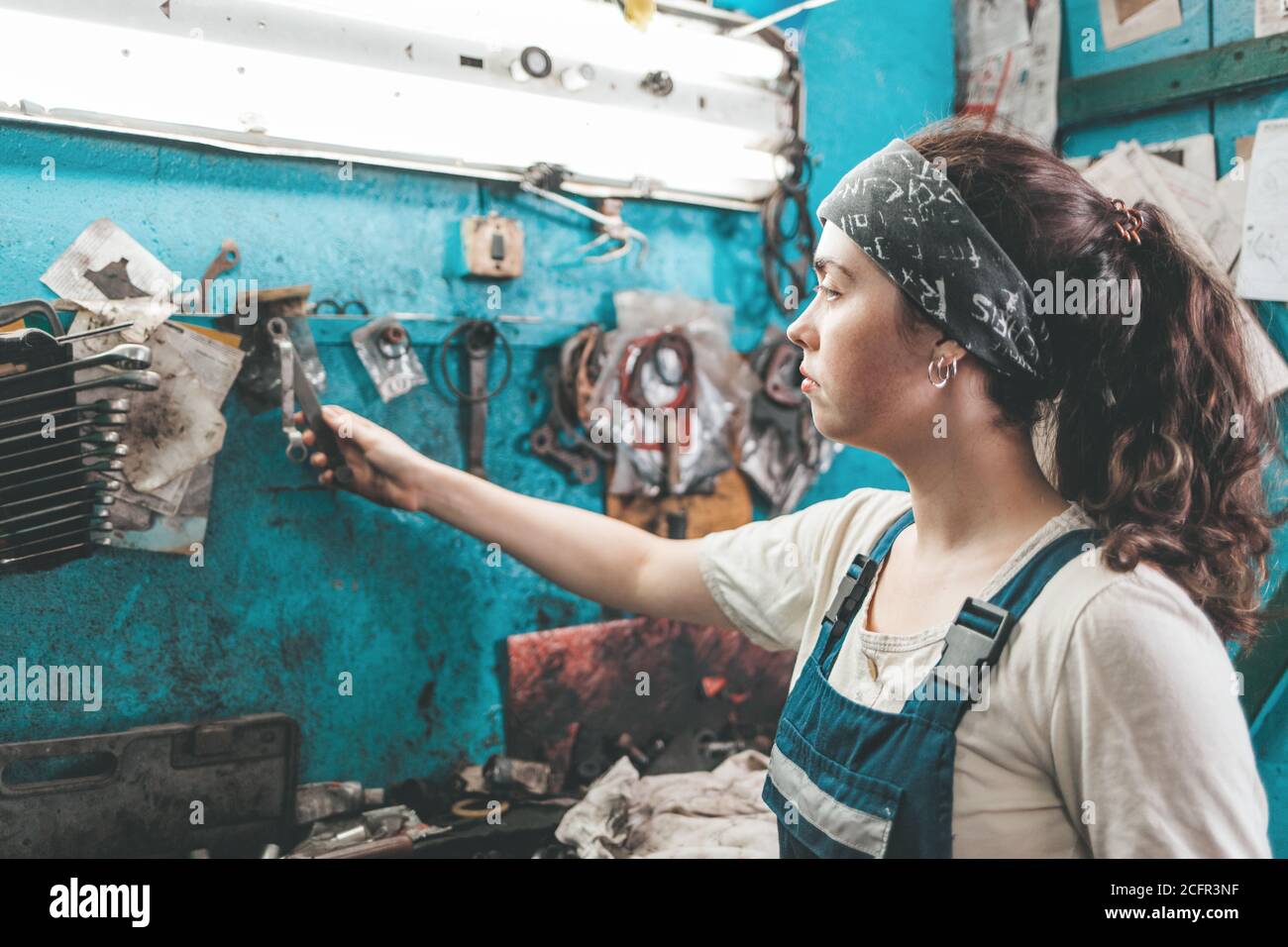 Gender equality. Portrait of a young smiling woman in uniform working ...