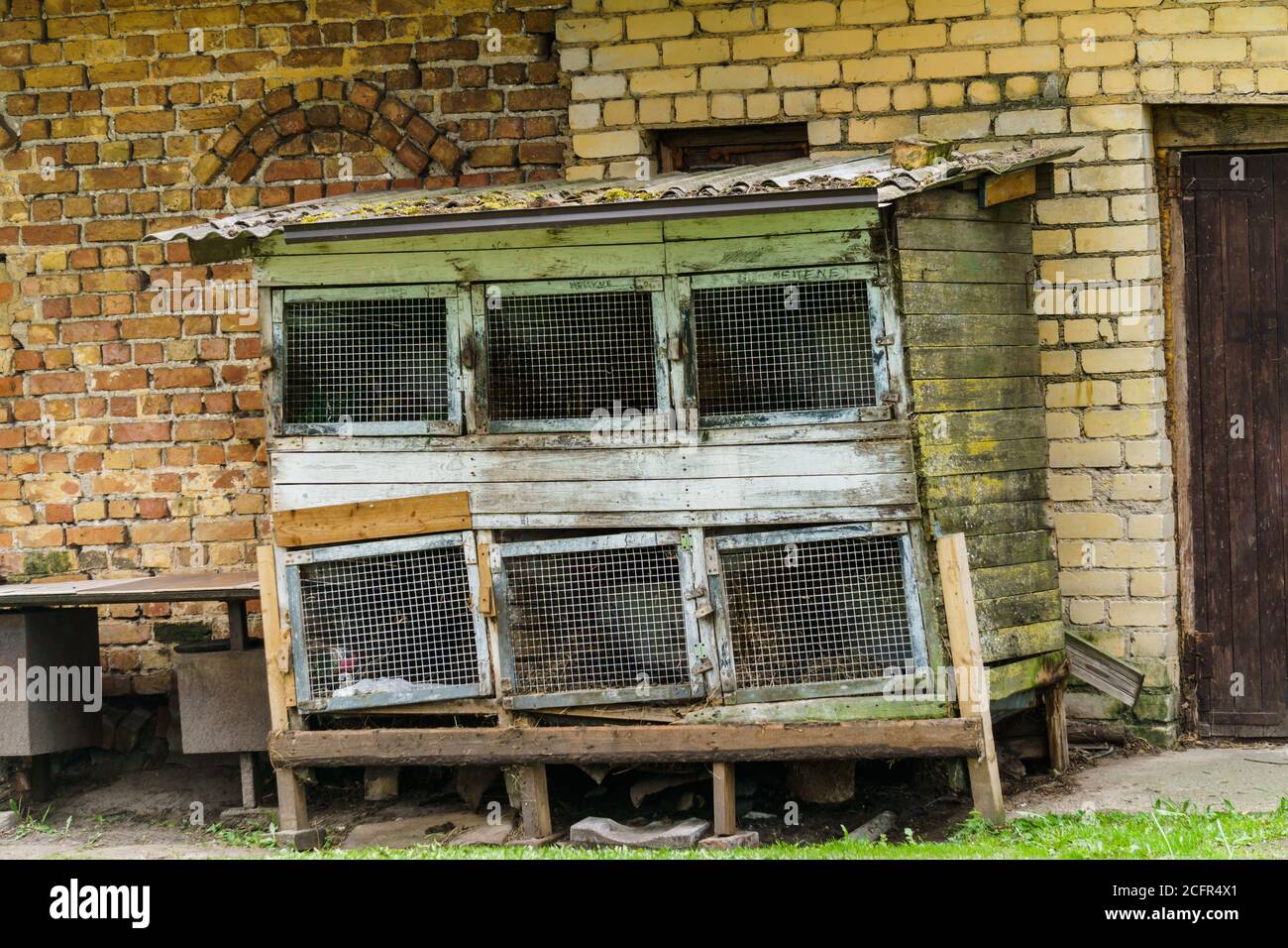 Rural life. Old cages for rabbits near a barn in the outback of Latvia ...