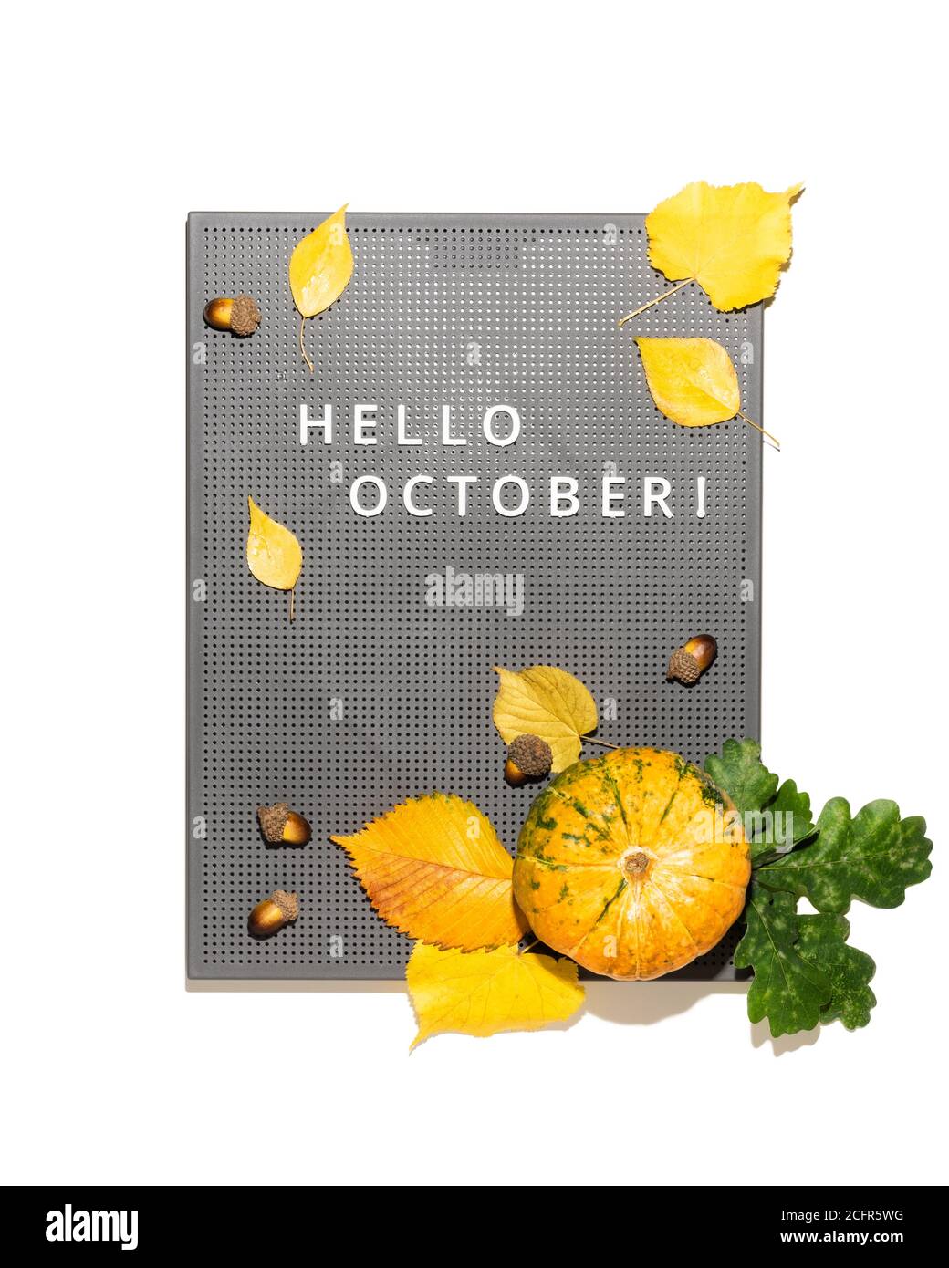 Hello october text on grey letter board and yellow and green fall ...
