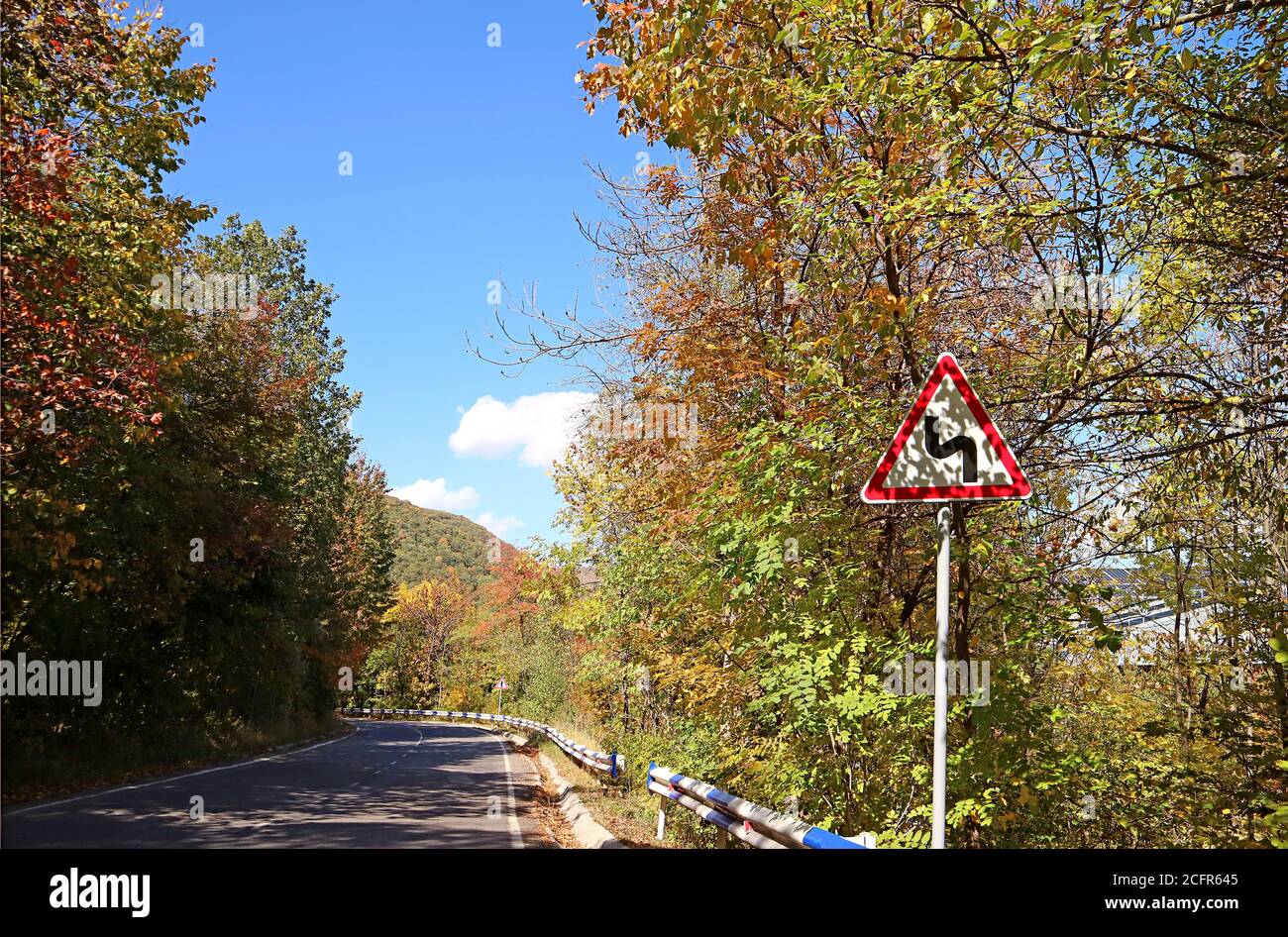 Left Reverse Bend Road Sign on the Windy Mountain Road among Fall ...