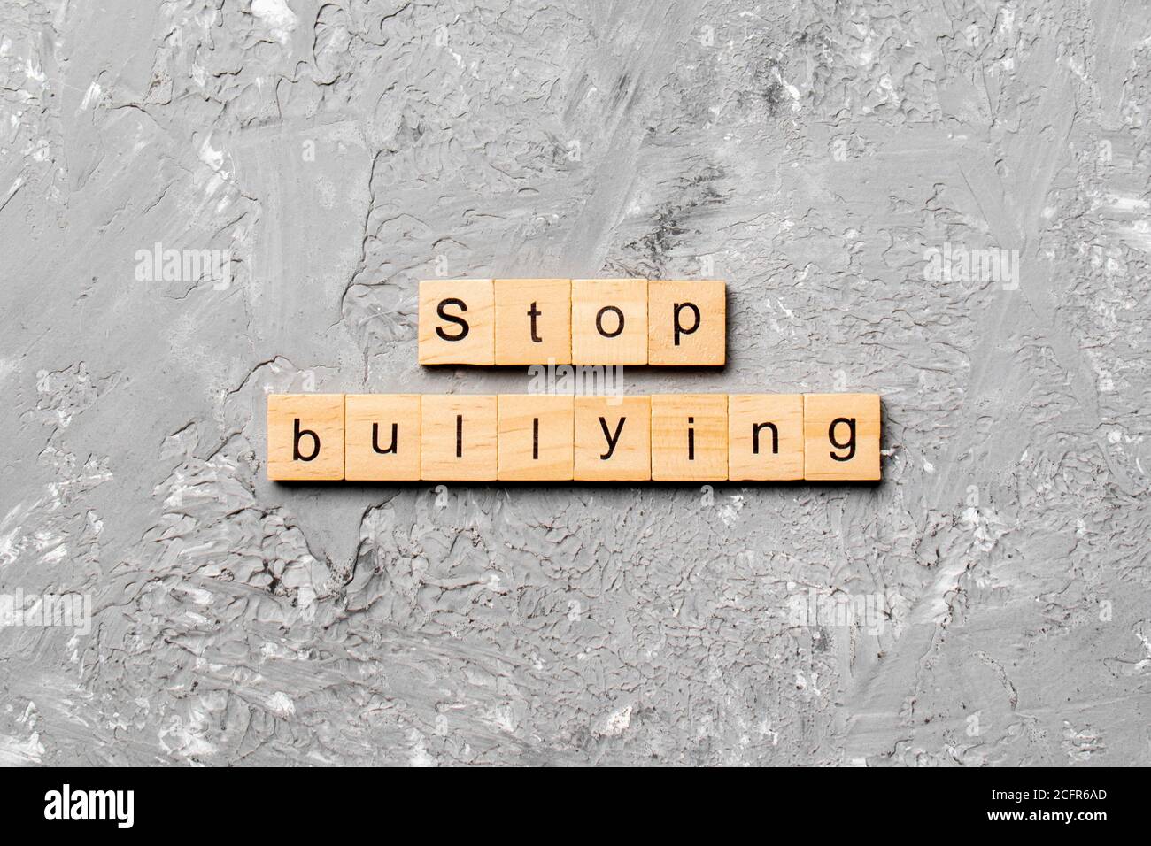 Stop Bullying word written on wood block. Stop Bullying text on cement ...