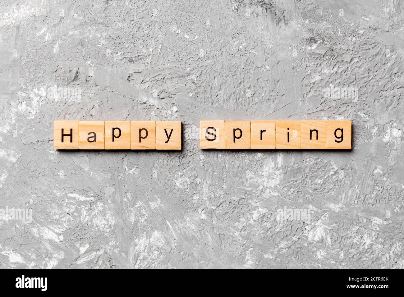 Happy Spring word written on wood block. Happy Spring text on cement ...