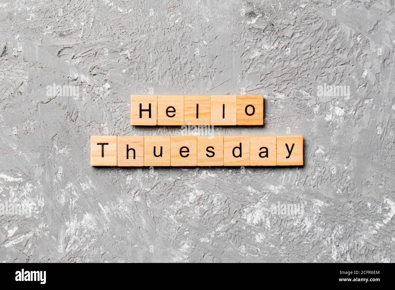hello Tuesday word written on wood block. hello Tuesday text on cement ...