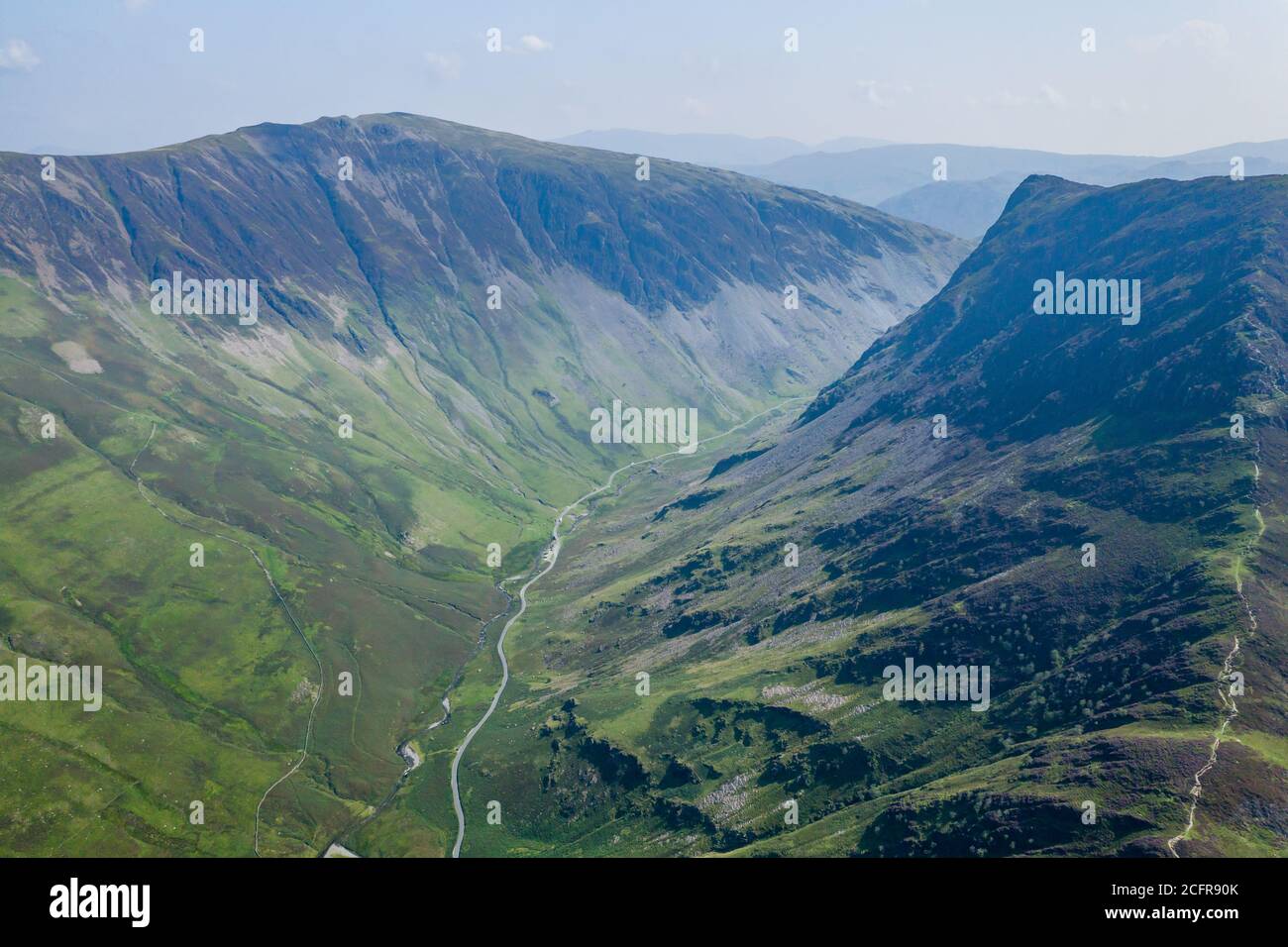 Aerial view of a road running through an impressive, narrow mountain ...
