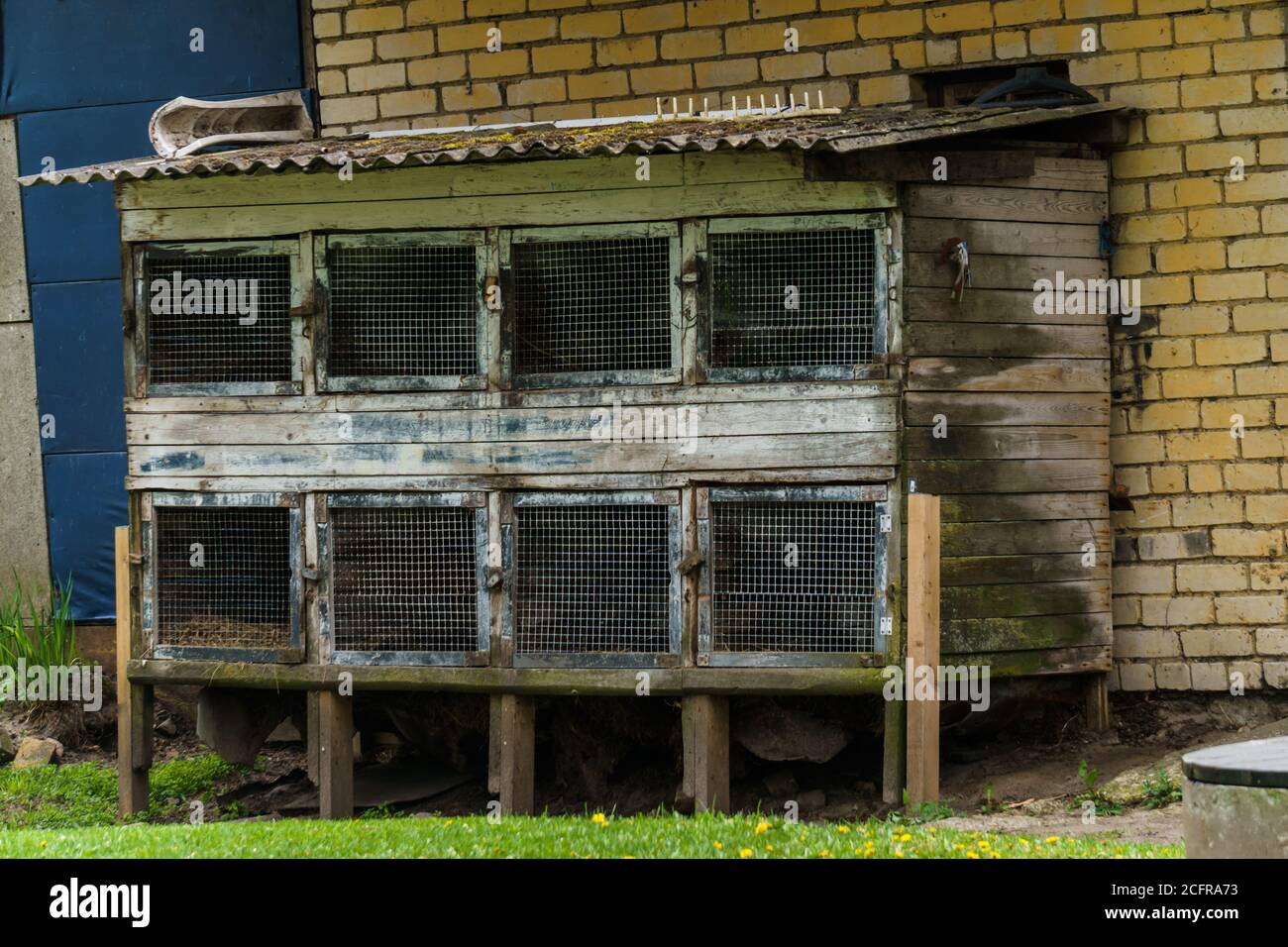 Rural life. Old cages for rabbits near a barn in the outback of Latvia ...