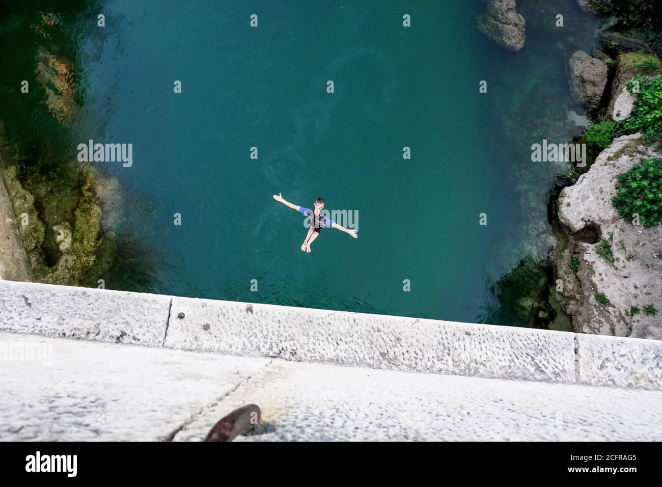 Bosnia-Herzegovina: Mostar. Diver who just jumped from the top of the ...