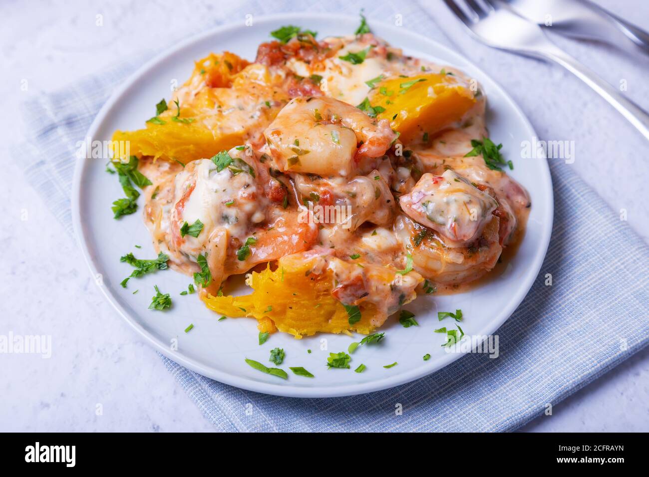 Pumpkin with shrimps and cheese. Traditional Brazilian dish. Close-up ...