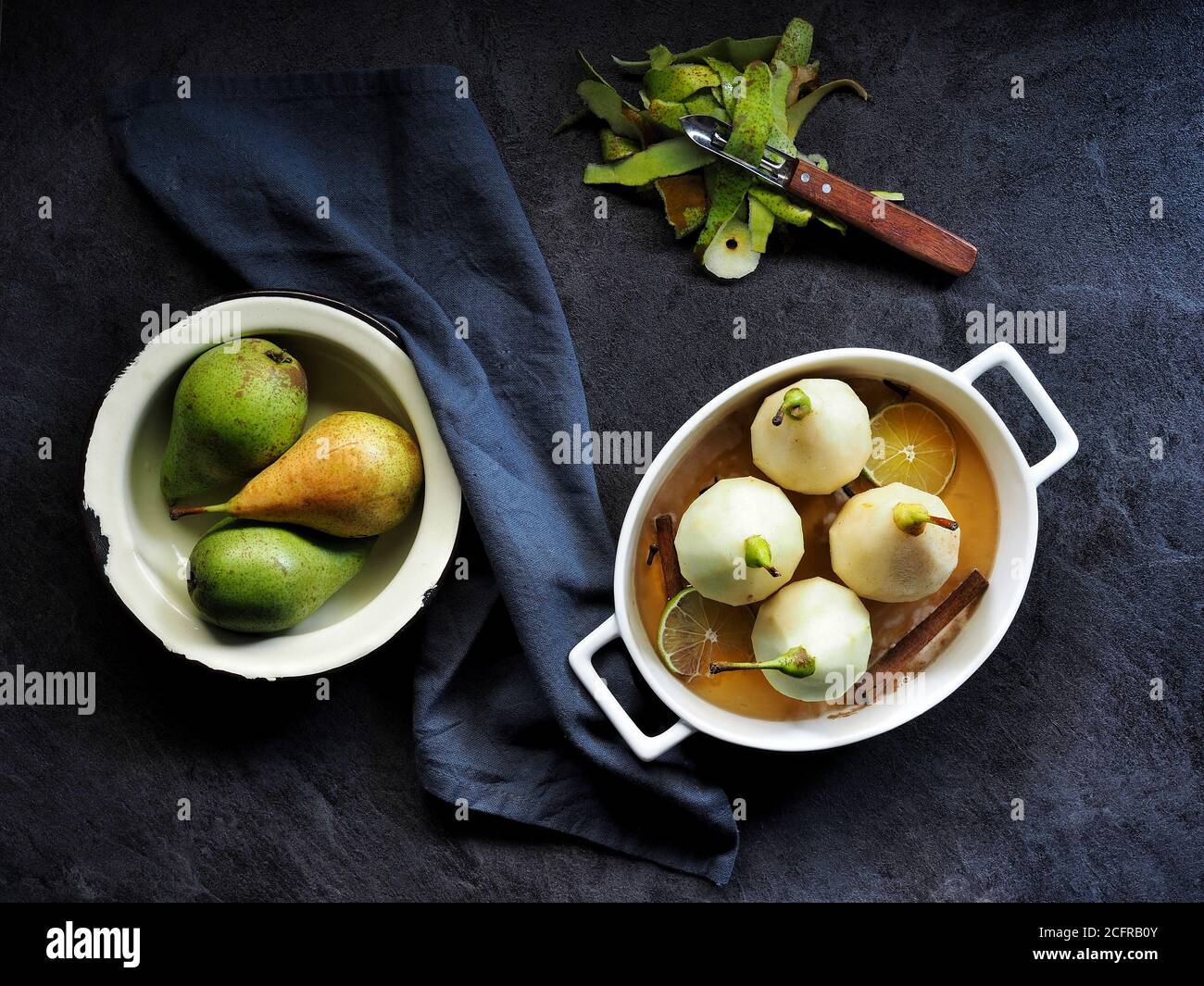 Four peeled pears ready to be roasted. Ingredients for recipe. Overhead ...