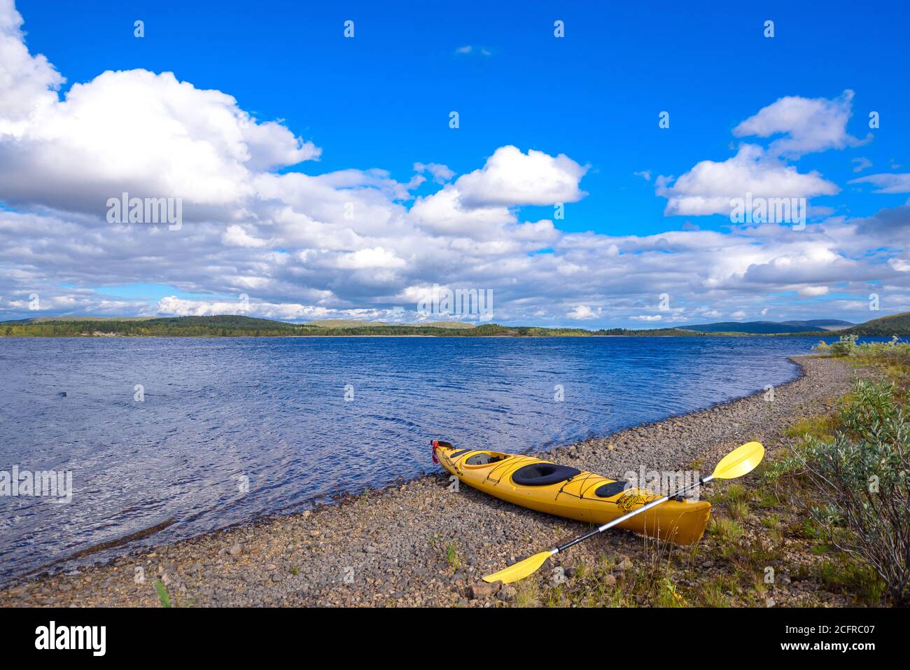yellow kayak on the lake blue sky Stock Photo - Alamy