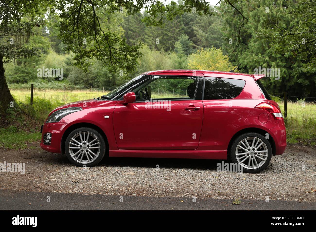 A red 2013 Suzuki Swift Sport parked in the uk countryside Stock Photo ...
