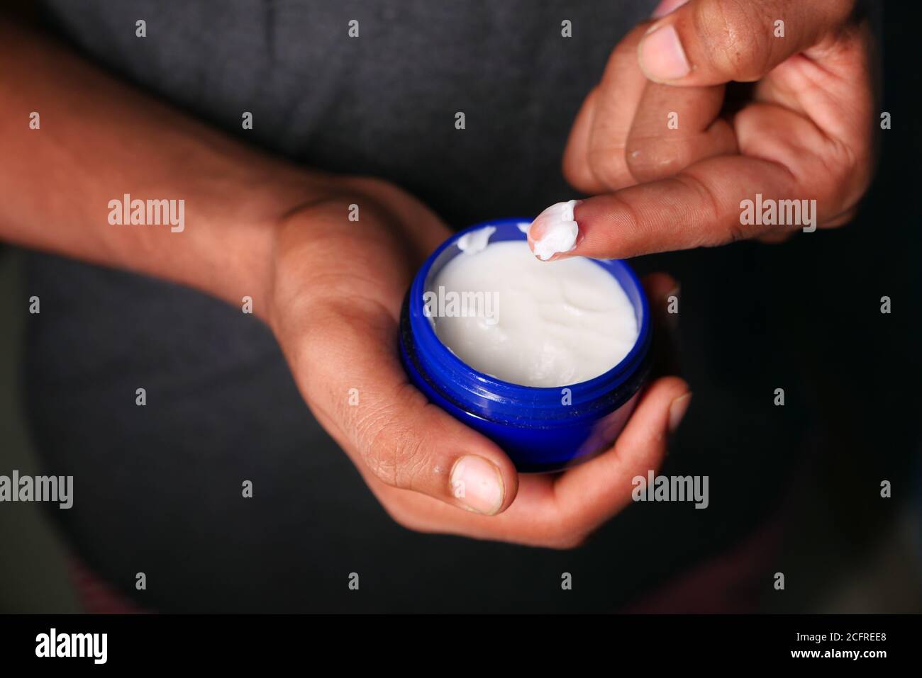 man applying beauty cream onto skin at home top view Stock Photo - Alamy