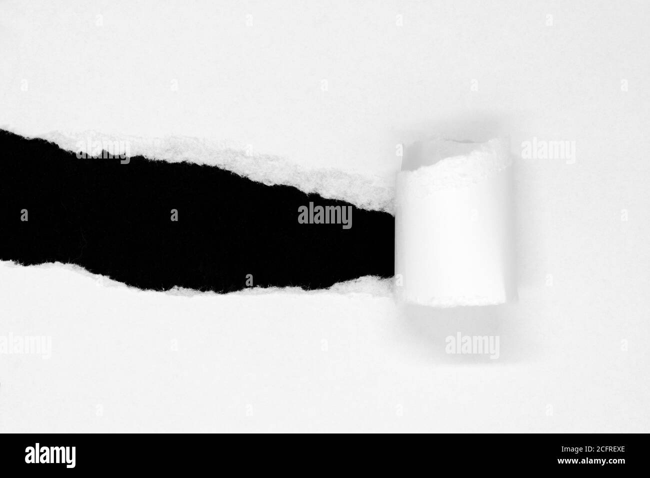 White ripped paper with twisted one side isolated on black background ...