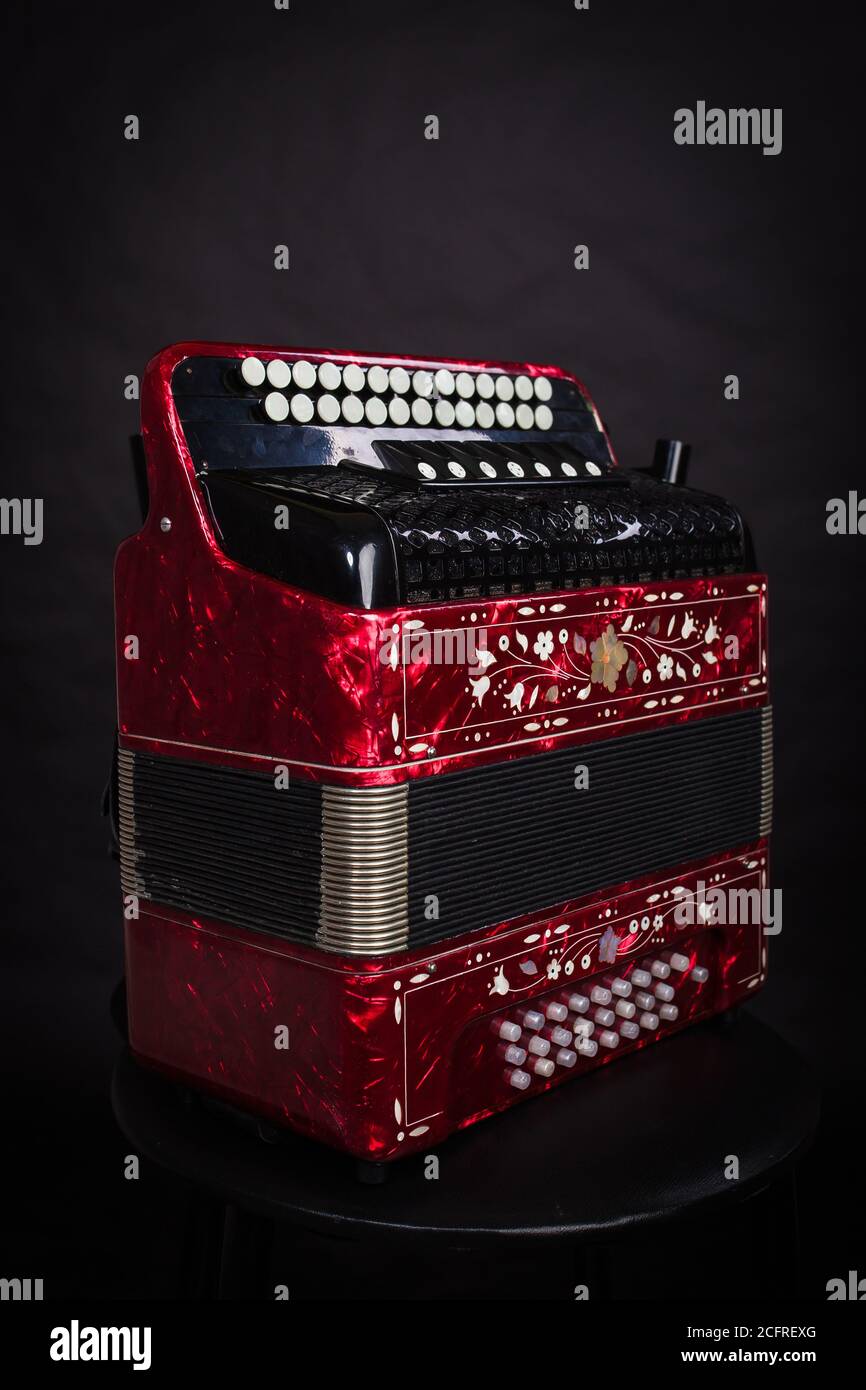 Russian folk instruments.Red bayan on a black background.Russian ...