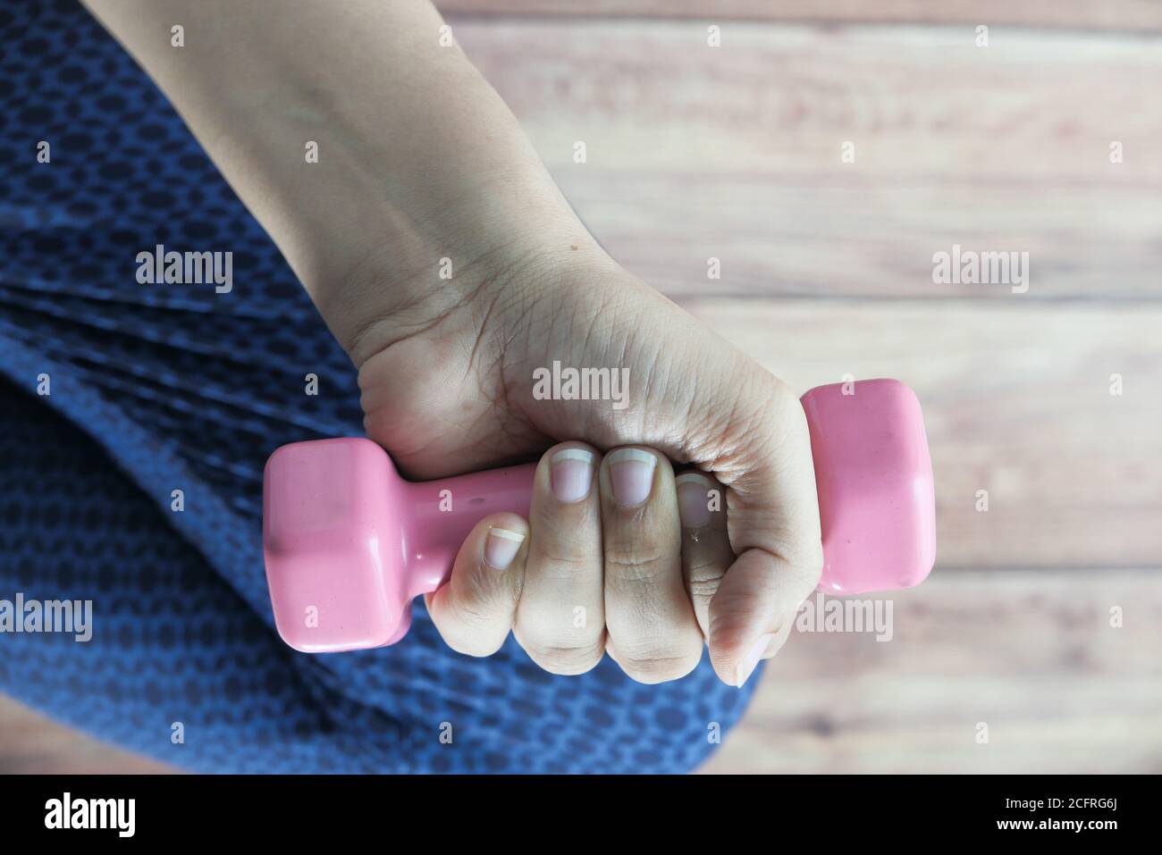 Young woman exercising with dumbbell weights top view Stock Photo - Alamy