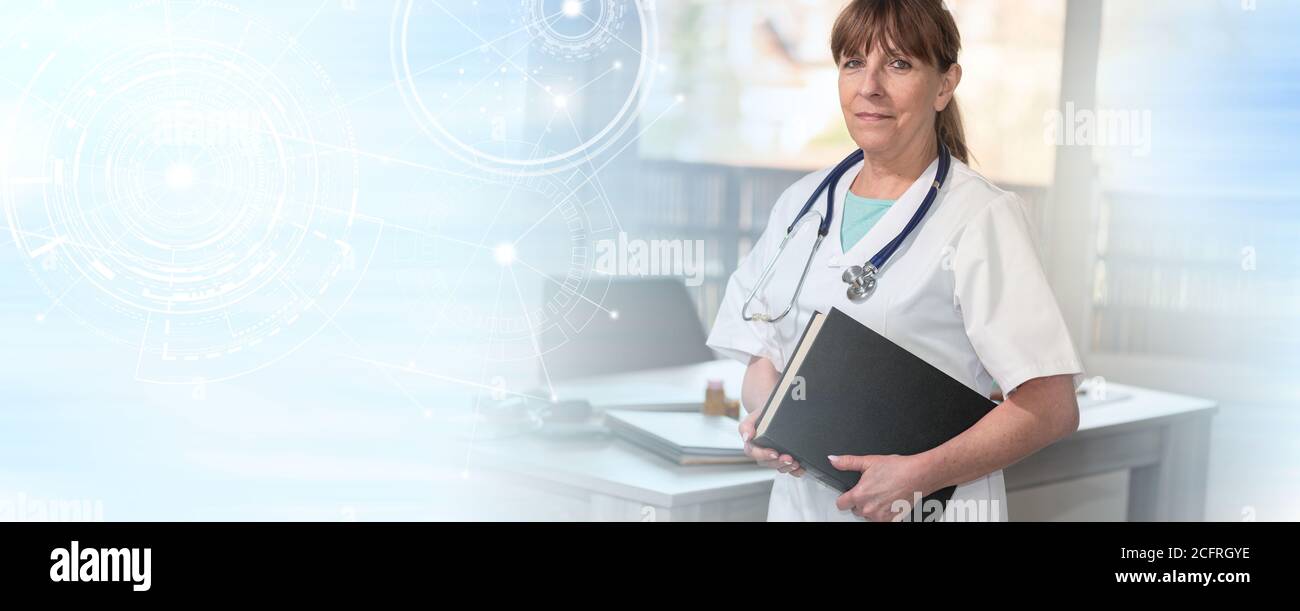 Portrait of female doctor standing and holding a medical textbook ...