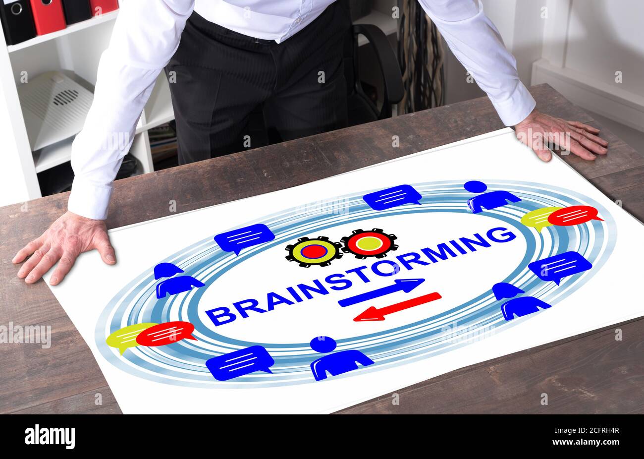 Man watching a brainstorming concept placed on a desk Stock Photo - Alamy