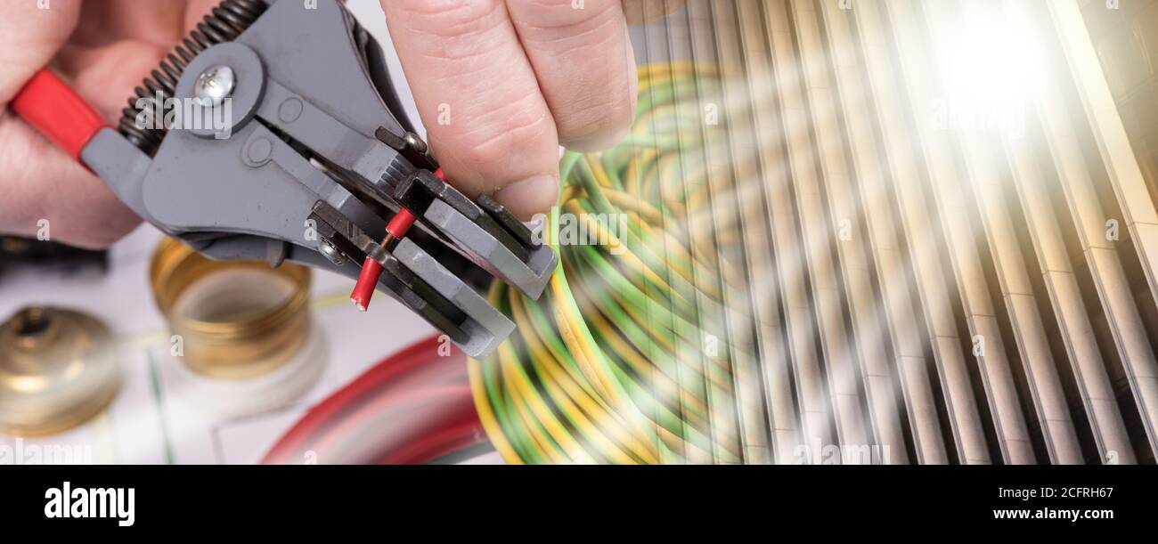 Action to strip a wire with a wire stripper, closeup; multiple exposure ...