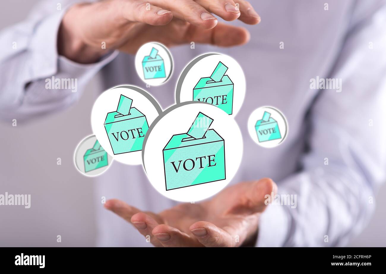 Vote concept between hands of a man in background Stock Photo - Alamy