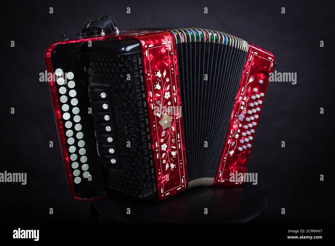Russian folk instruments Red bayan on a black background.Russian ...