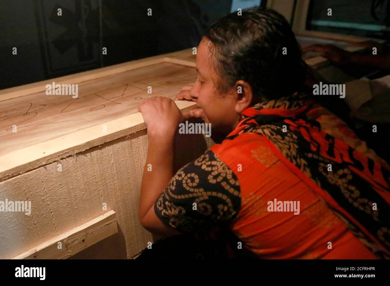 Dhaka, Bangladesh - August 07, 2020: Relatives mourn for Imon Hossain Imran, 30, as they come to ...