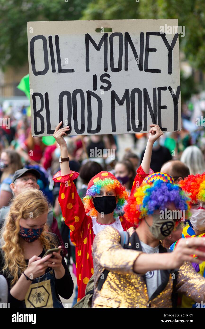 Performer in clown costume holding placard, 'Carnival of Corruption ...