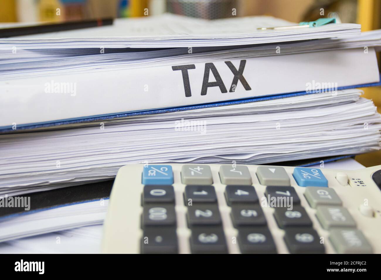 Folder Tax documents and paper files with calculator concept Annual tax ...