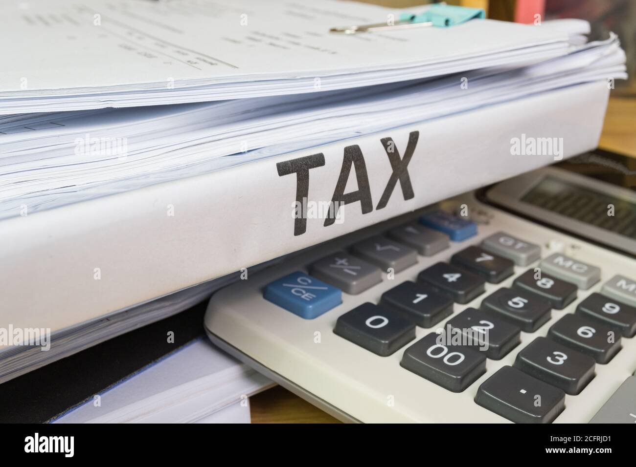 Folder Tax documents and paper files with calculator concept Annual tax ...