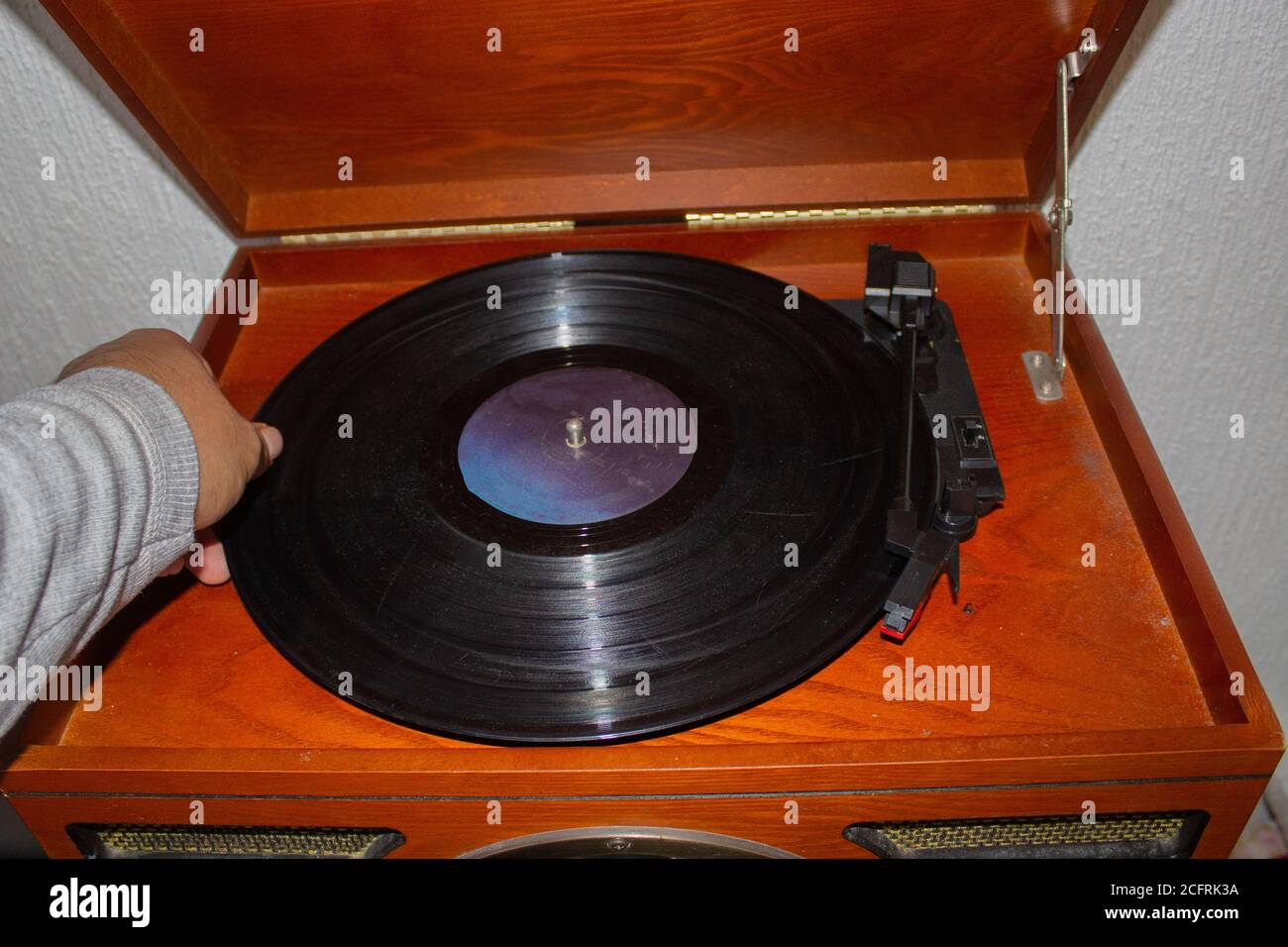 personal perspective of man putting acetate record on record player ...