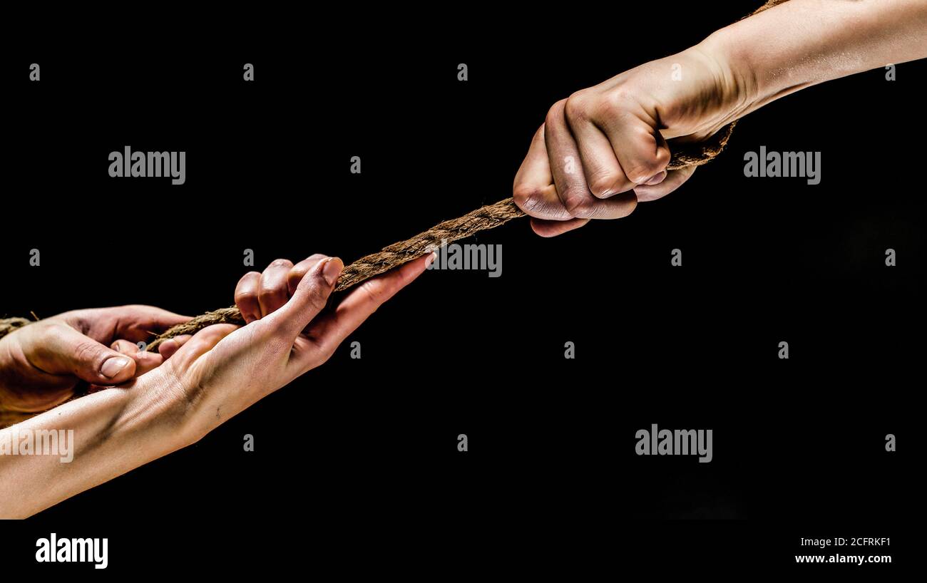 Conflict, tug-of-war, rope. Hand holding a rope, climbing rope ...
