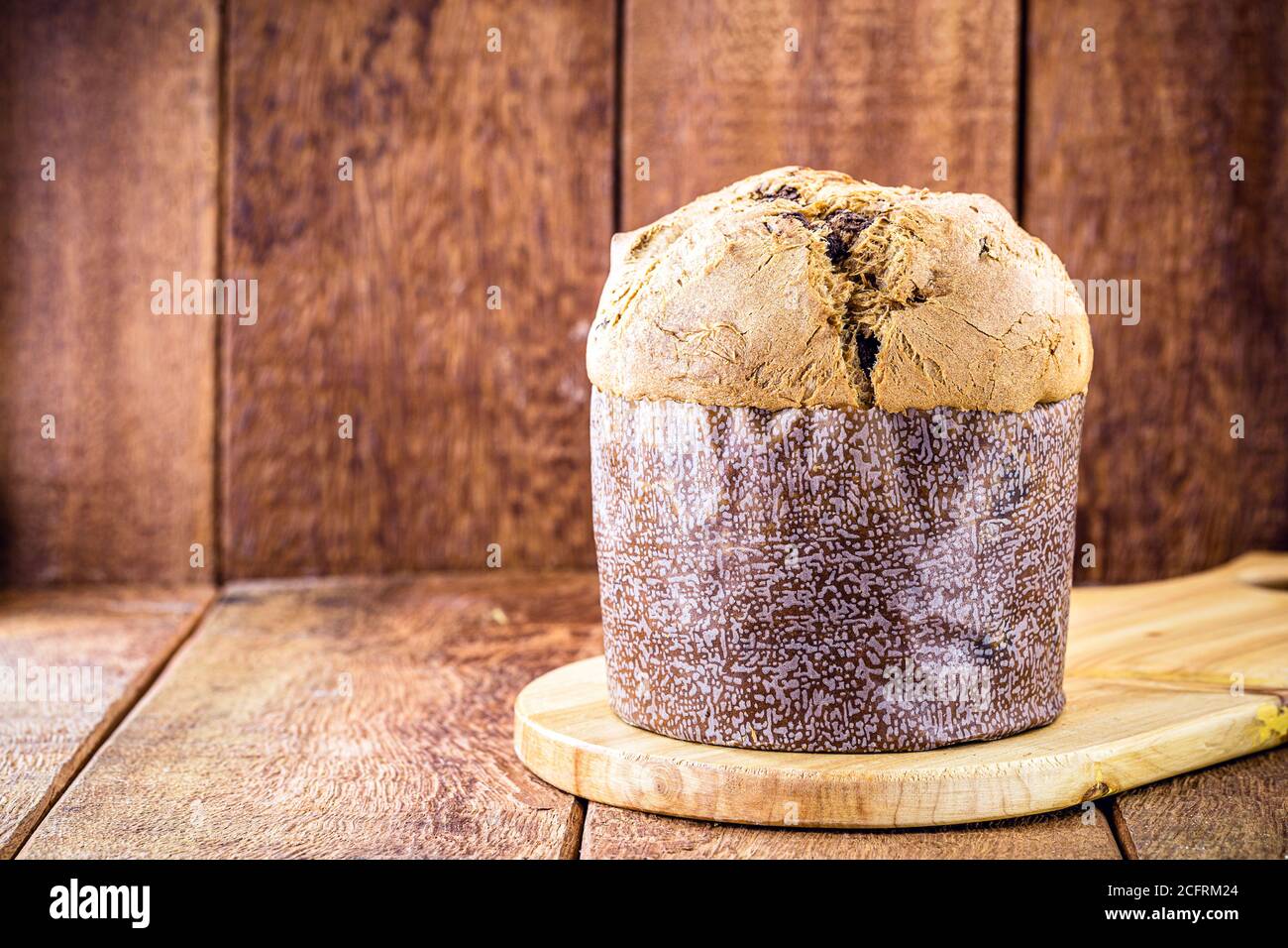 chocolate panettone isolated on rustic wooden background, space for ...