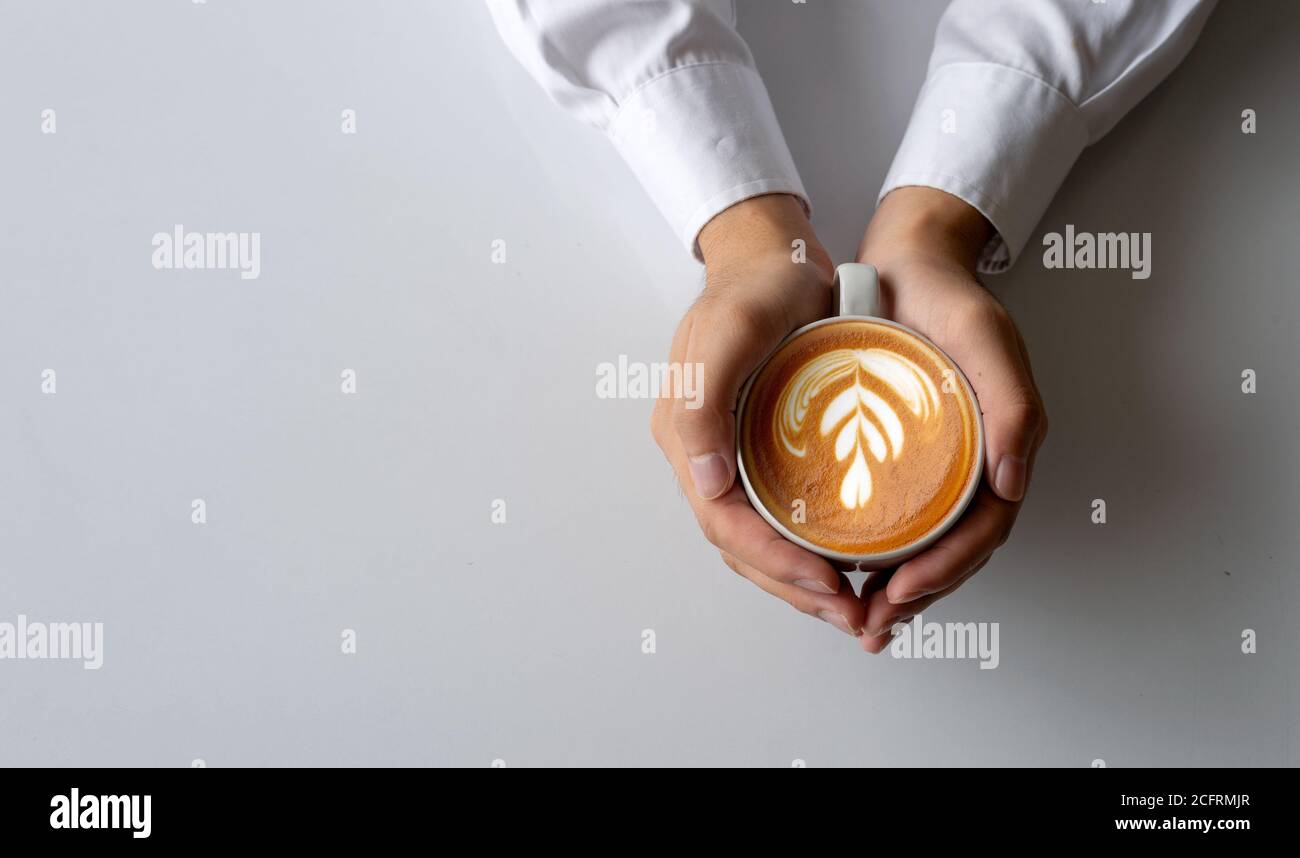 closeup man hands holding cups of coffee on white table background ...