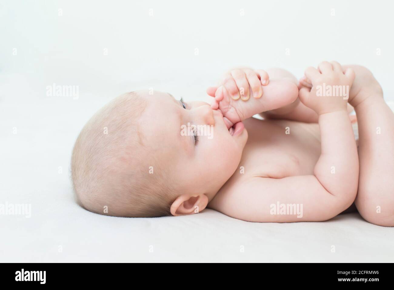 Cute adorable baby girl lying on the bed Stock Photo - Alamy