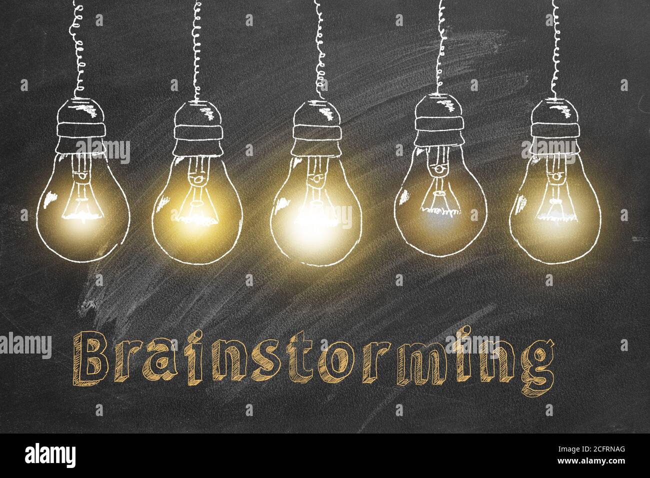 Row of tungsten light bulbs drawn in chalk on a blackboard. Concept of ...
