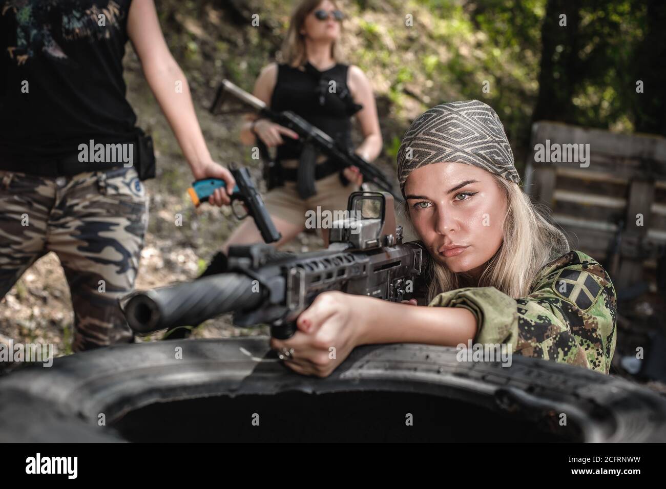 Combat team squad of attractive female military soldier have war training. Woman with weapon ...