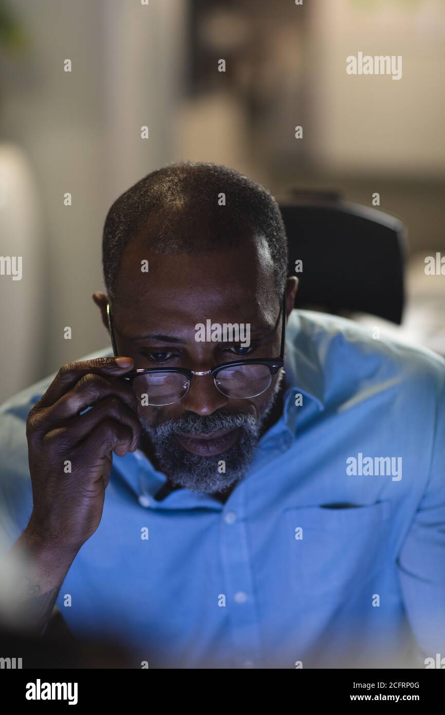 Senior businessman wearing glasses using computer in modern office ...