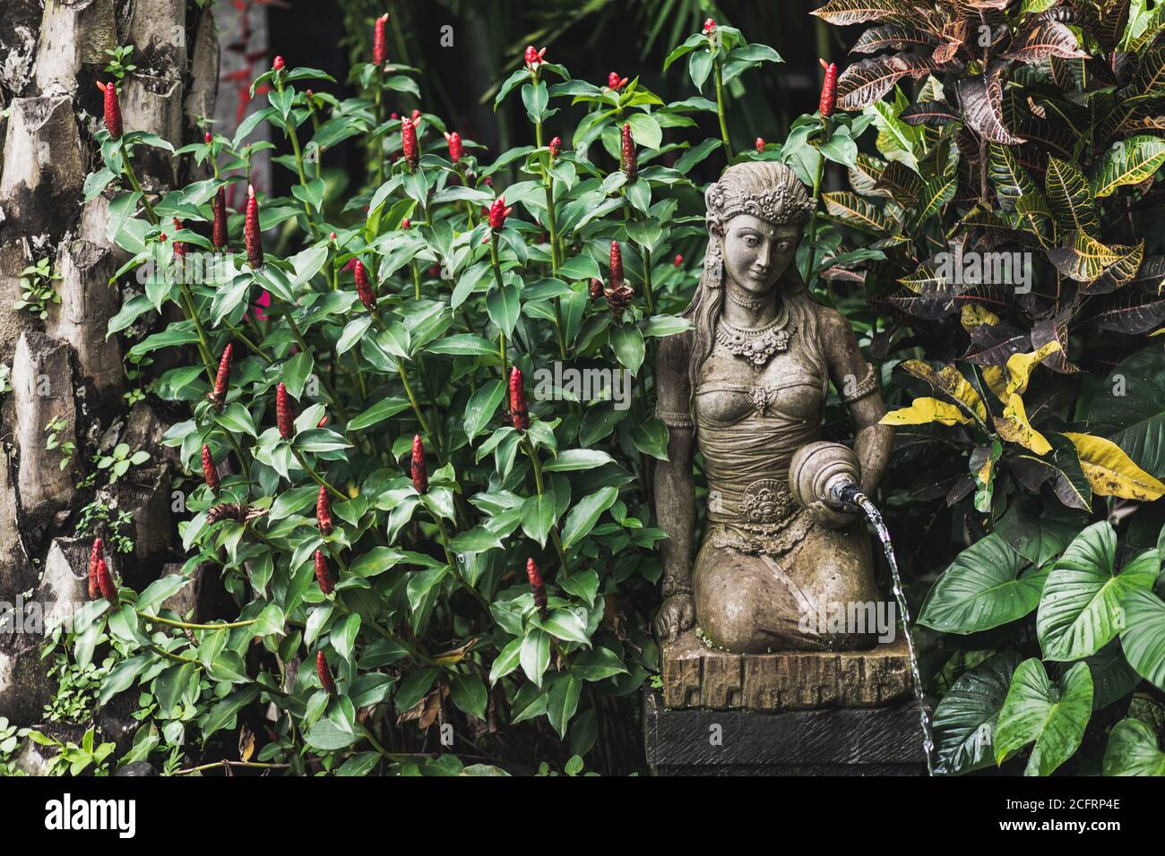 Female stone carved statuette as fountain in balinese traditional ...