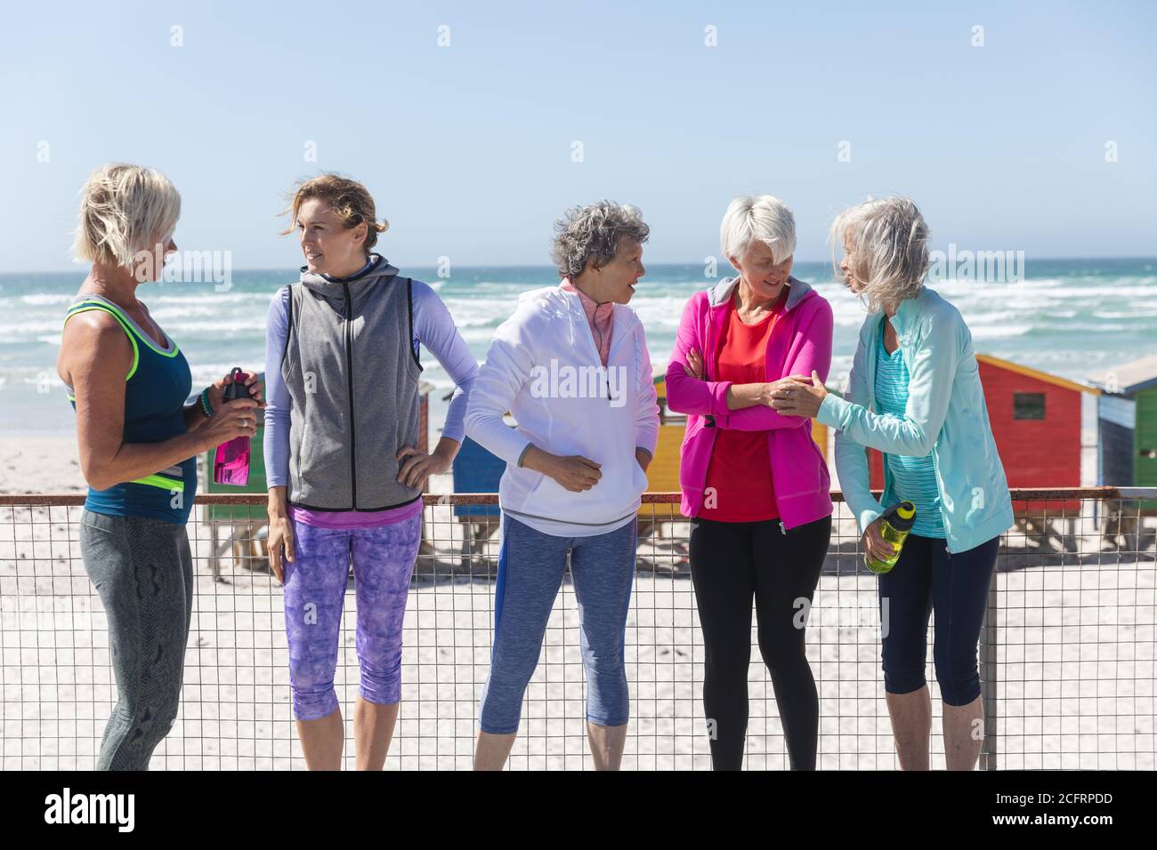 Group of woman talking on the beach Stock Photo - Alamy