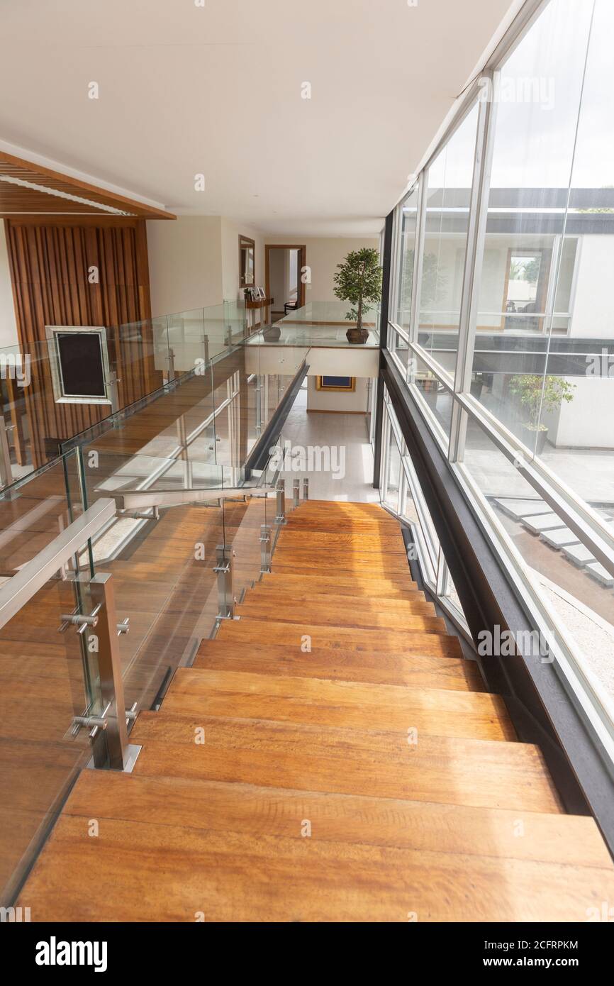tiered wooden corridor, a window and glass handrail, elegant interior ...
