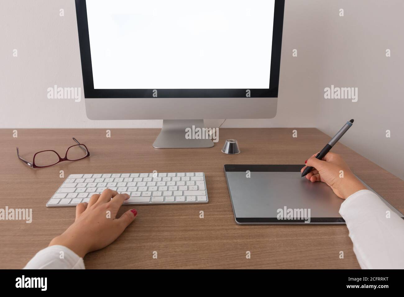 front view of a woman working on her computer inside an office with a ...