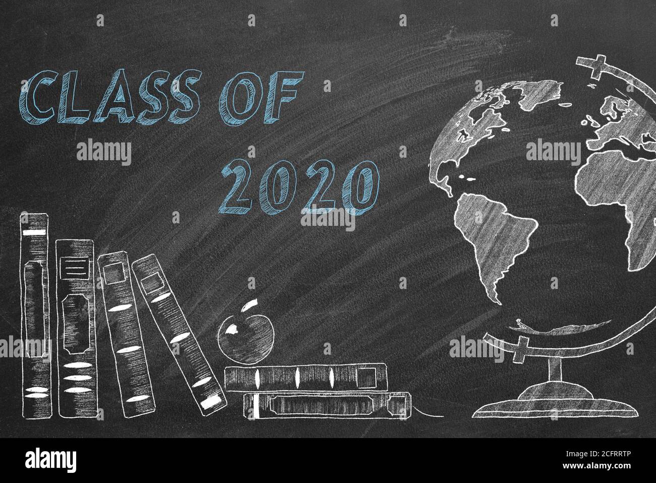 Lettering CLASS OF 2020, globe and school books are drawn with chalk on ...