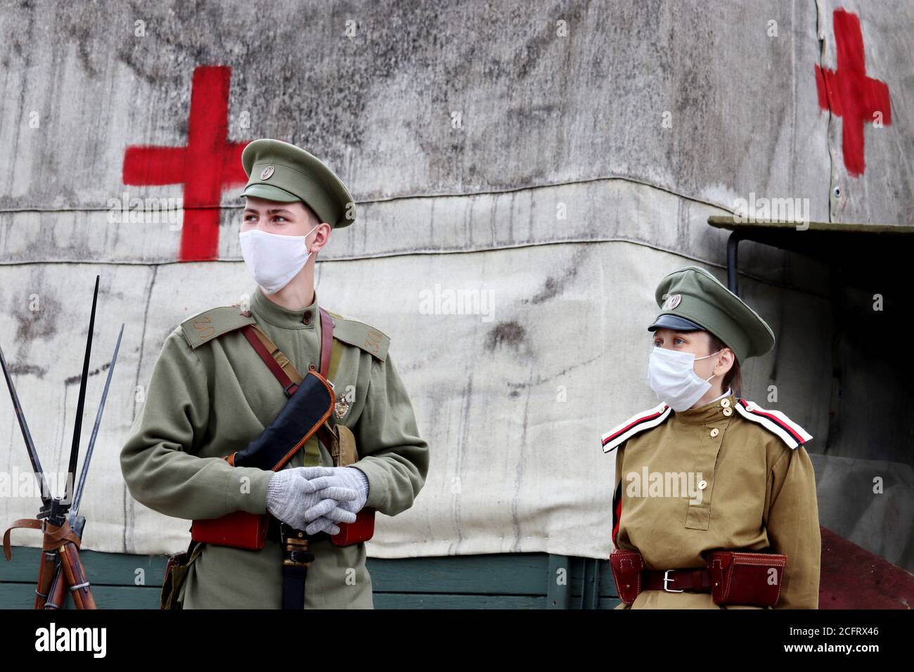 Soldiers of the Russian Empire of early 20th century in masks the field ...