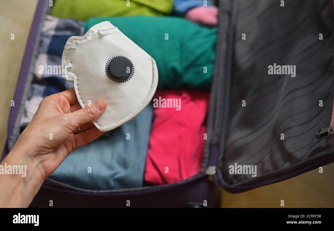 Safe Travel Bag Packed With Clothes, And Medical Masks Stock Photo - Alamy