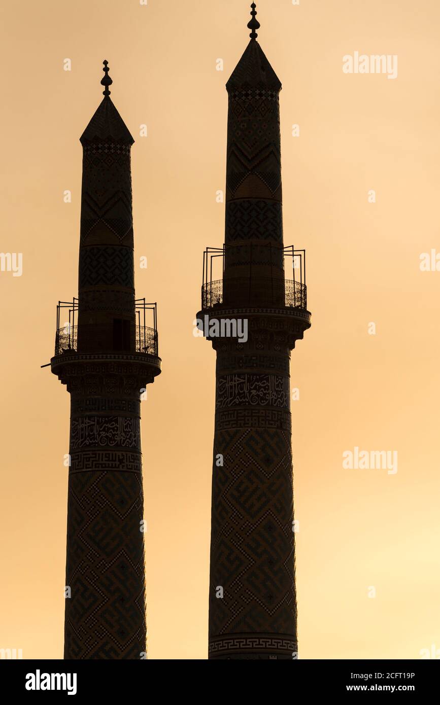 Silhouette of two minarets in sunset lights in Yazd, Iran Stock Photo ...