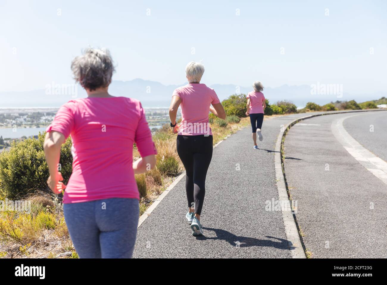 Rear view of group of woman running Stock Photo - Alamy