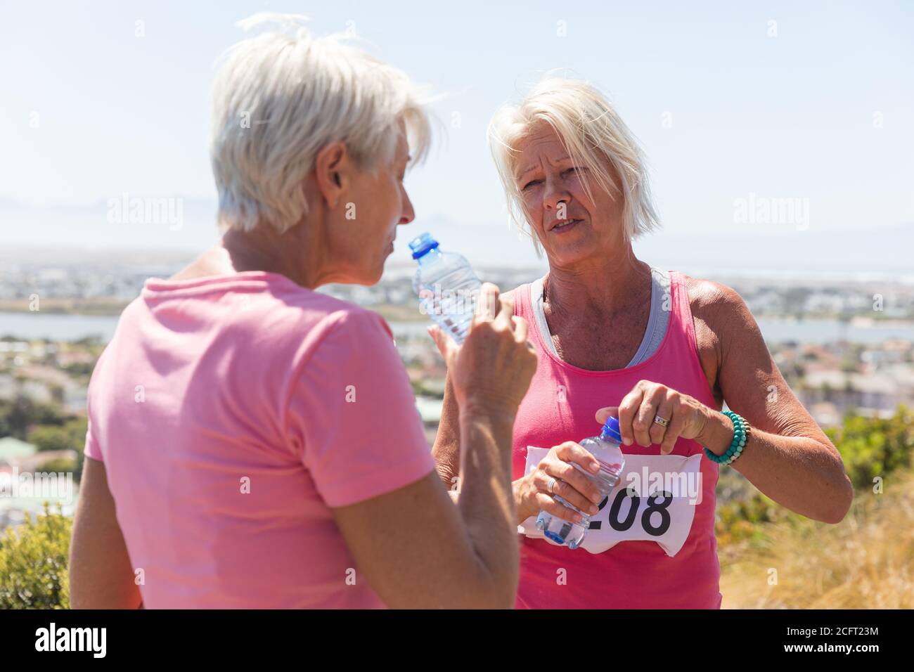 Two senior woman drinking water Stock Photo - Alamy